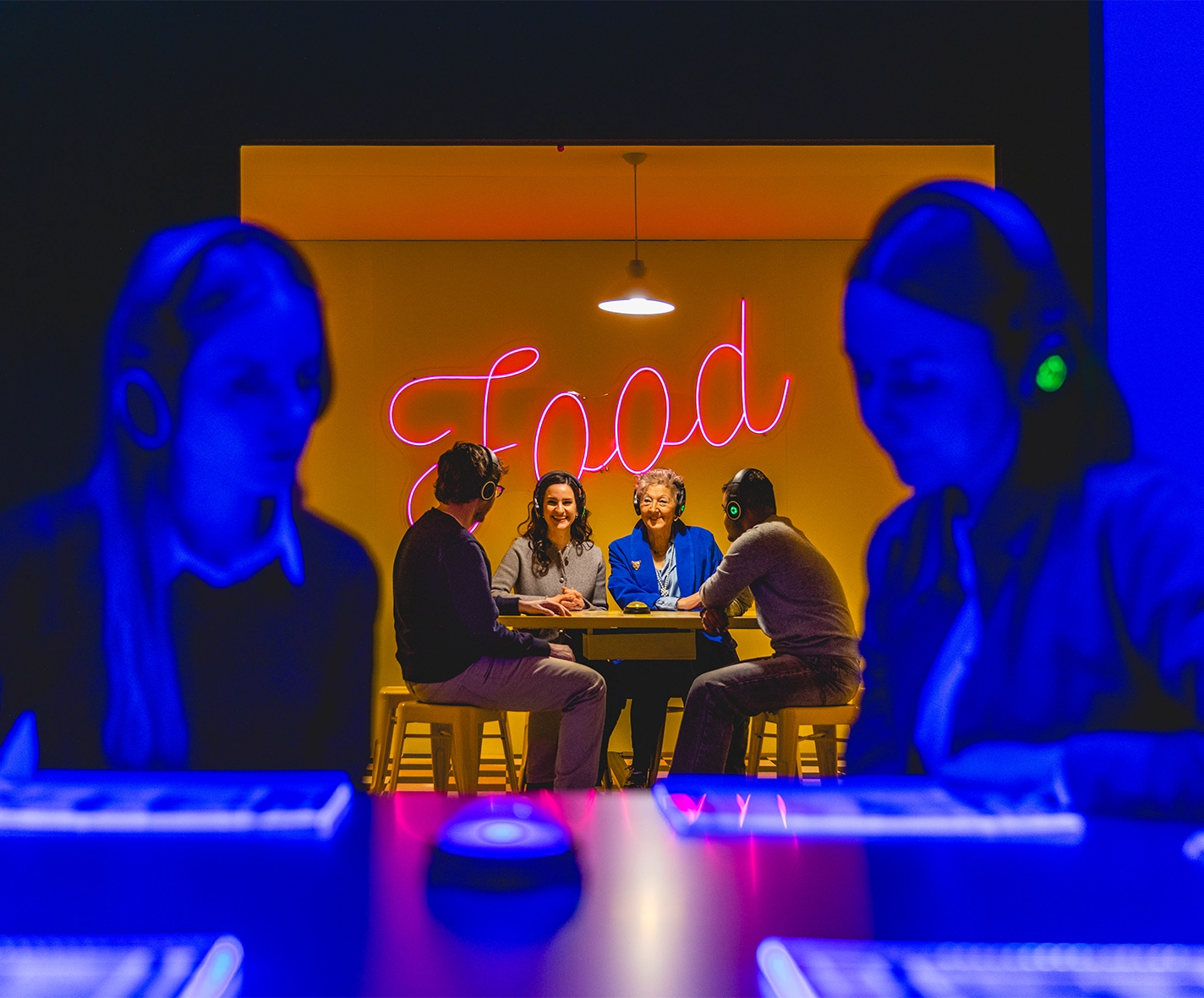 Visitors engage with the “Food Sound” exhibition in Trento, seated ...